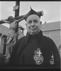 Father Maurice with crucifix - ECU Digital Collections